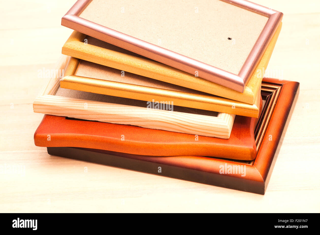 Stack of picture frames isolated on a wooden background Stock Photo - Alamy