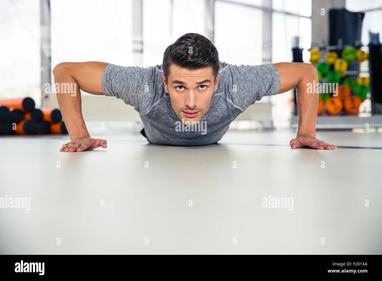 Portrait of a handsome man doing push-ups in gym Stock Photo - Alamy