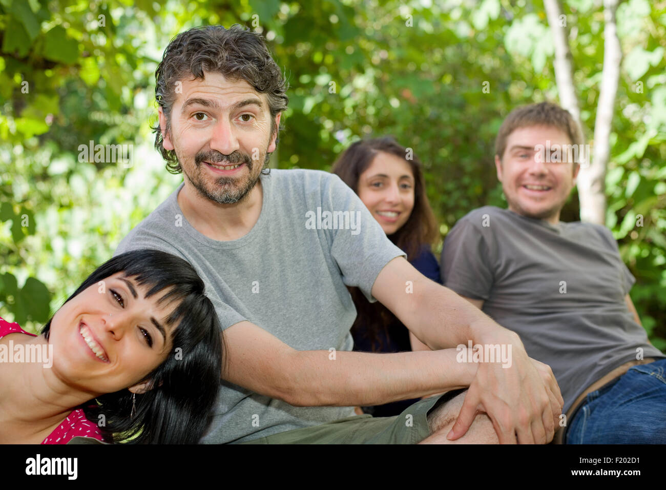 group of friends relaxing outdoors, focus on the man on the left Stock ...