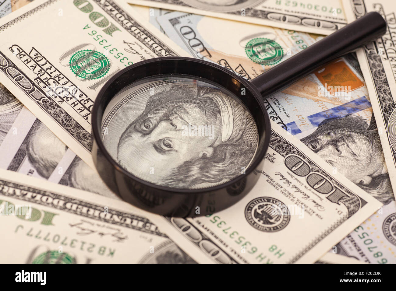 Hundred dollar banknotes under magnifying glass Stock Photo - Alamy
