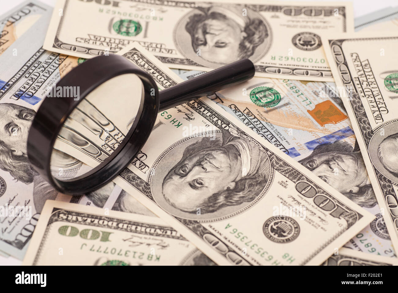 Hundred dollar banknotes under magnifying glass Stock Photo - Alamy