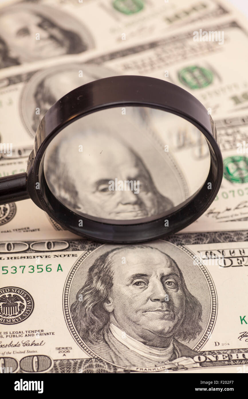 Hundred dollar banknotes under magnifying glass Stock Photo - Alamy