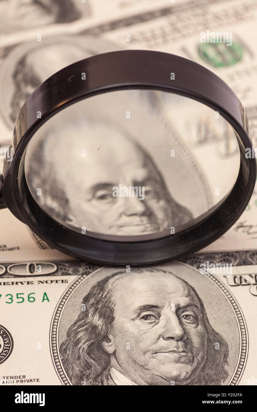 Hundred dollar banknotes under magnifying glass Stock Photo - Alamy