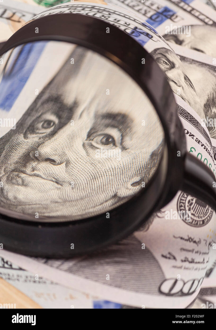 Hundred dollar banknotes under magnifying glass Stock Photo - Alamy