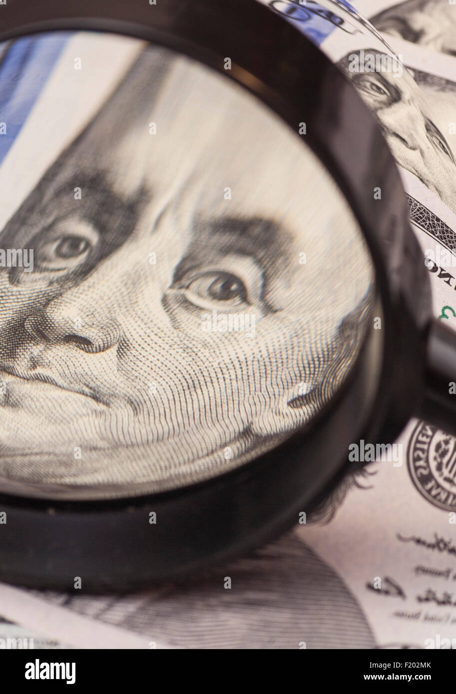 Pile dollars under magnifying glass hi-res stock photography and images ...