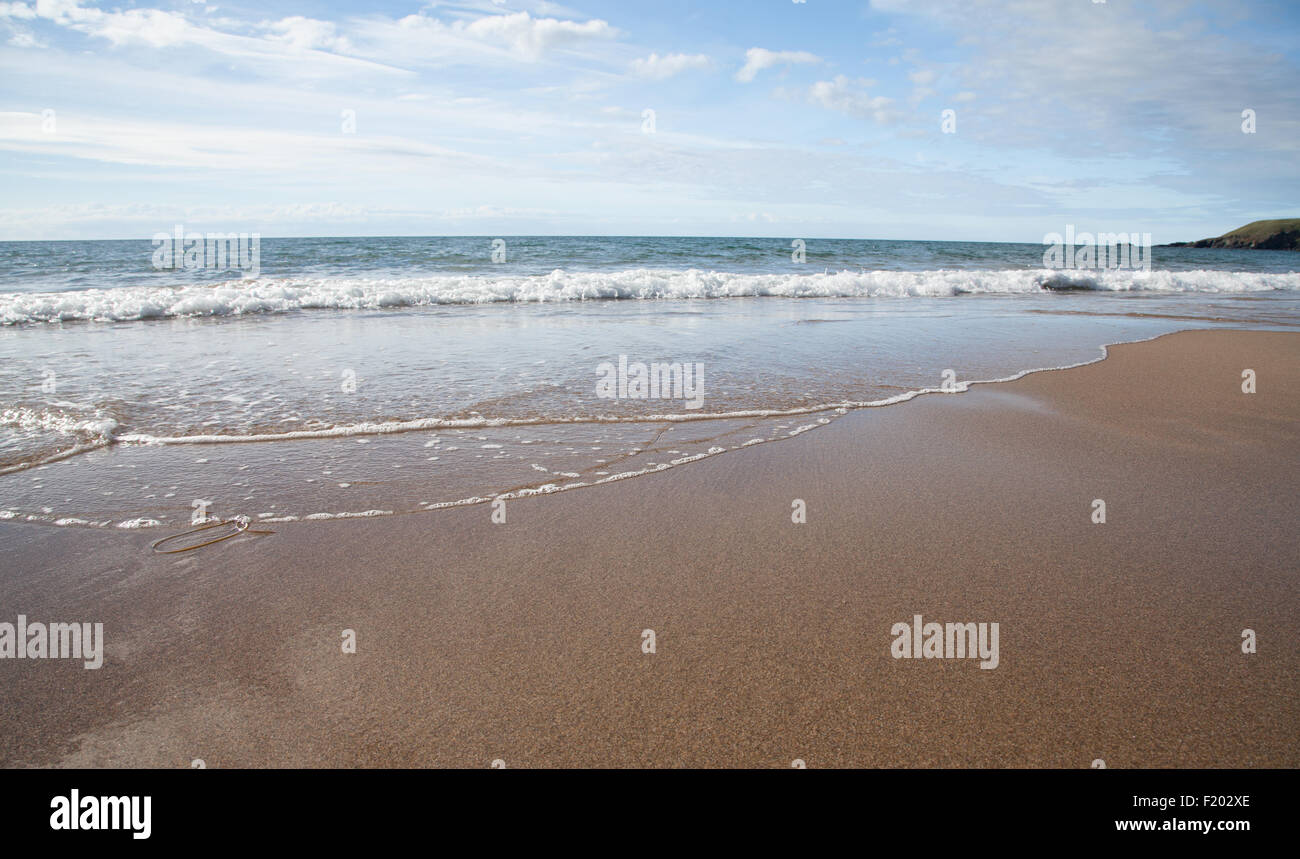 Waves lap gently at the beach at Porth Oer / Whistling Sands, Aberdaron ...
