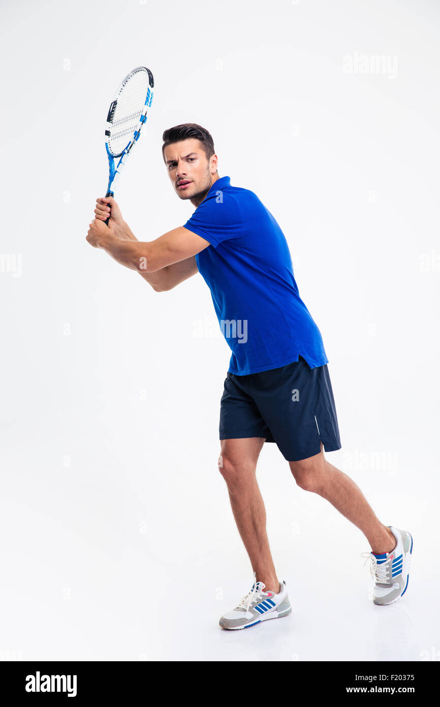 Full length portrait of a handsome man playing in tennis isolated on a ...