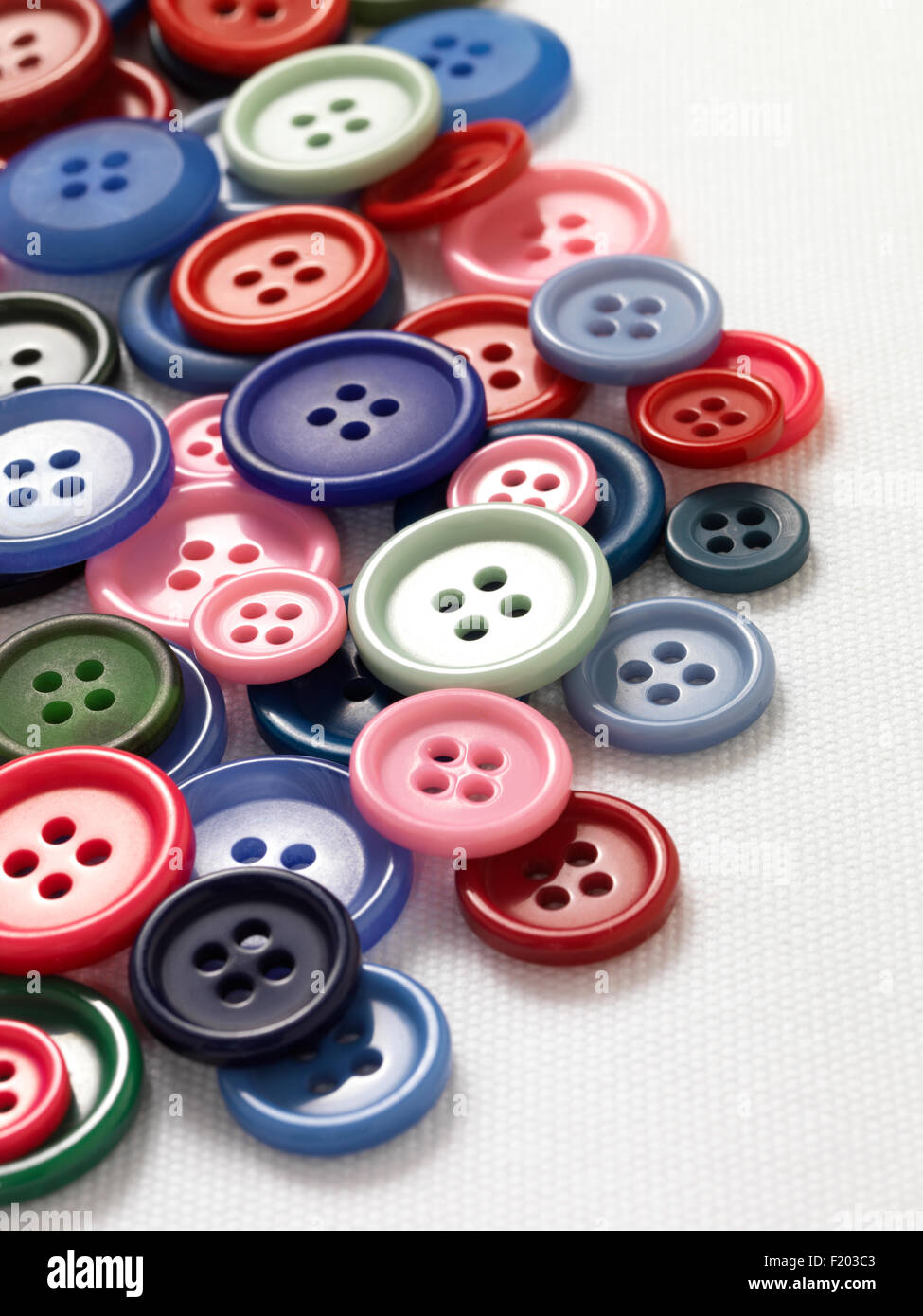 Buttons on white cotton background Stock Photo - Alamy