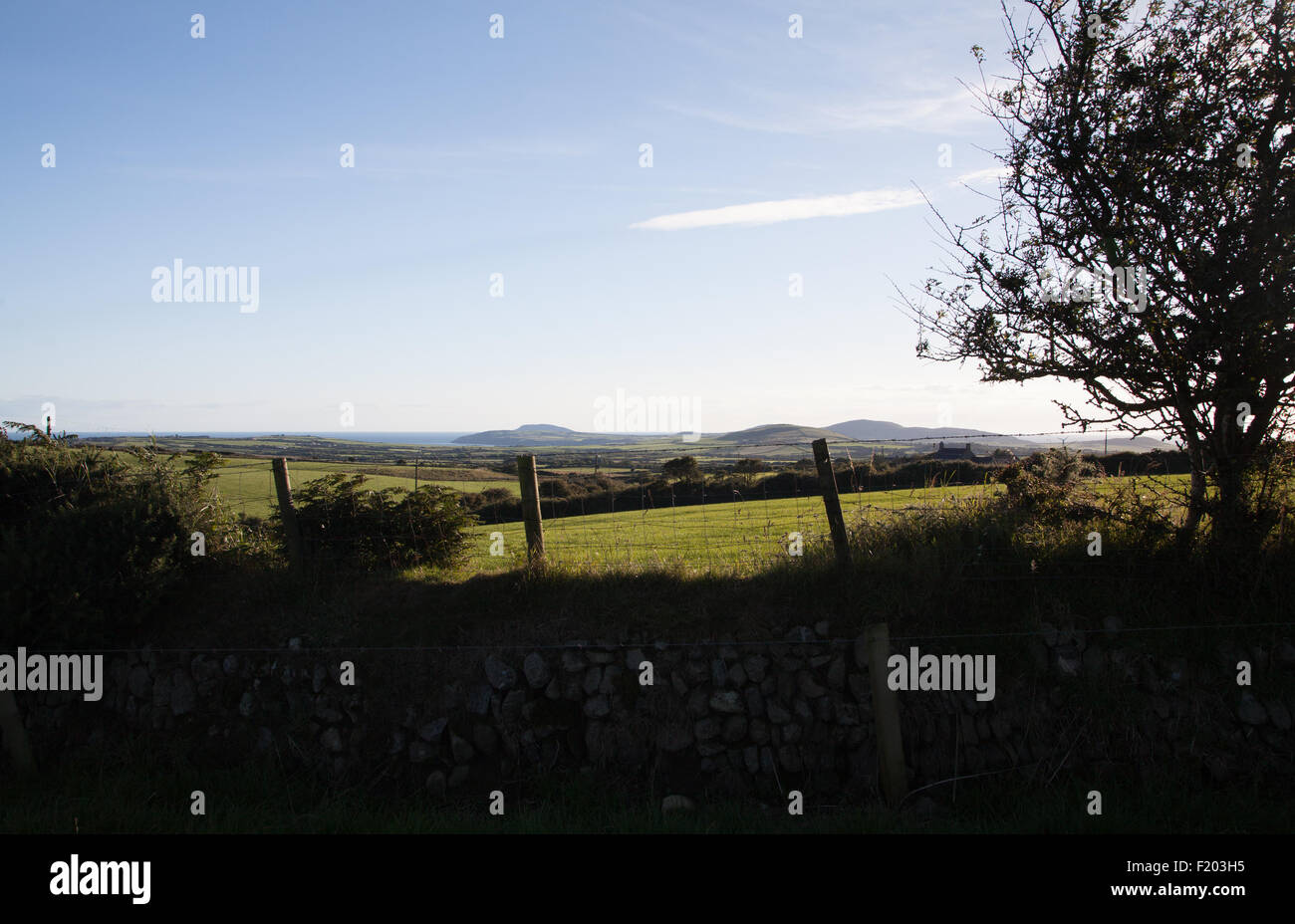A view across green fields towards Aberdaron, Uwchmynydd and Ynys Enlli ...