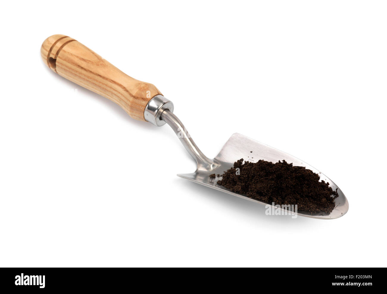 soil with garden trowel isolated on a white background Stock Photo - Alamy