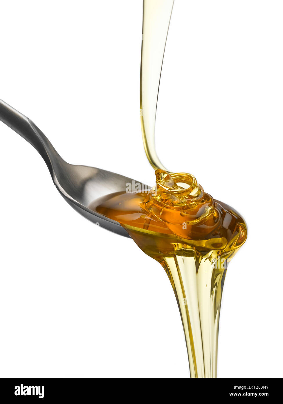 Golden Treacle flowing onto a spoon Stock Photo - Alamy