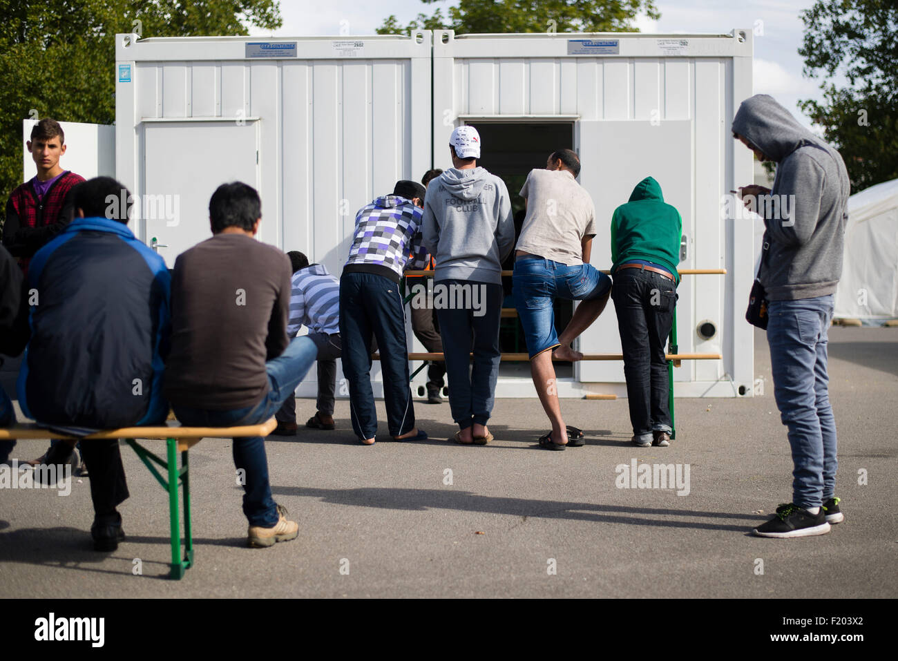 Berlin, Germany. 9th Sep, 2015. Refugees wait to be registered in front ...