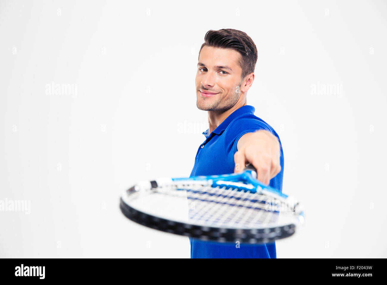 Portrait of a smiling man holding tennis racket isolated on a white ...
