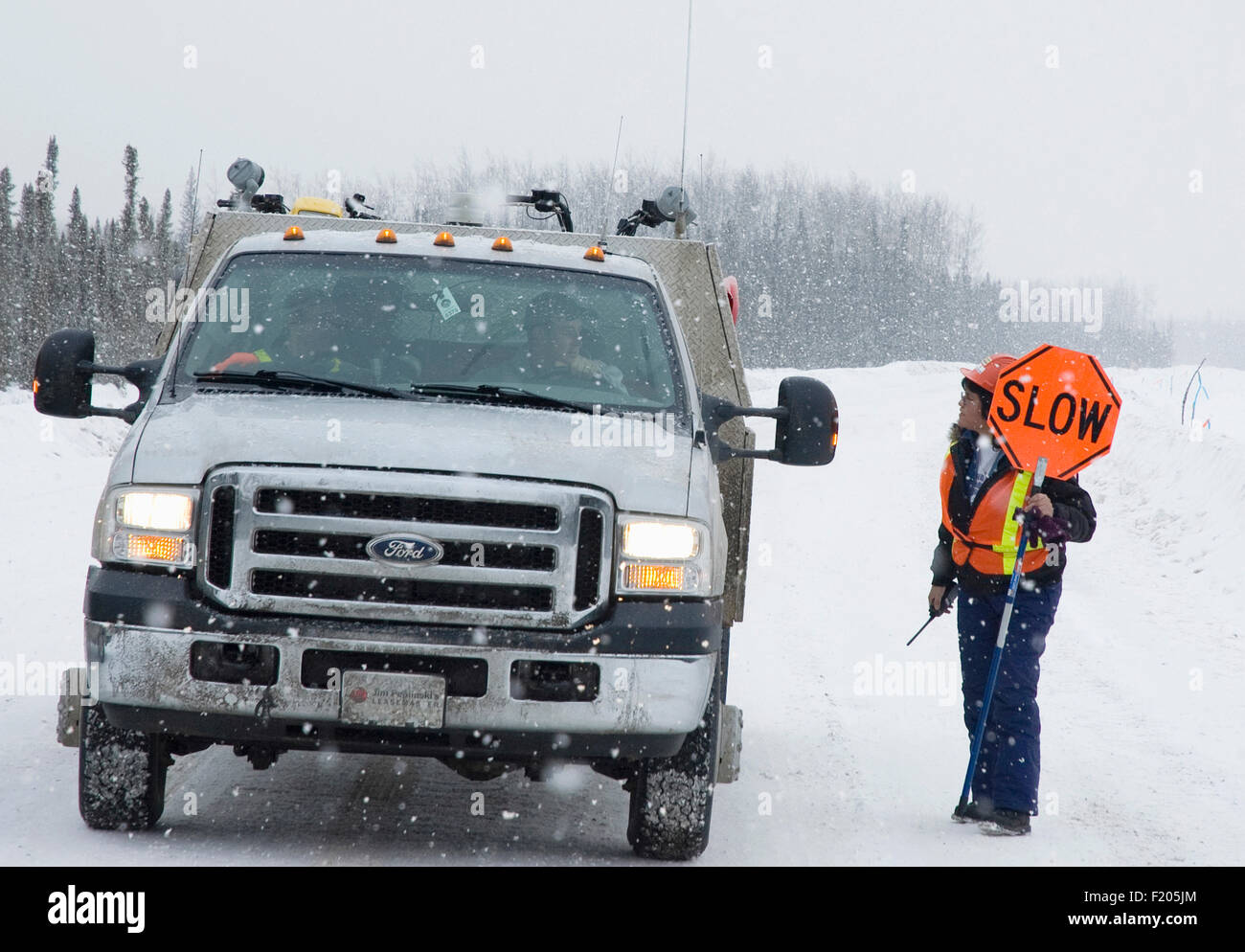 Canada, Alberta, Wabasca, Metis First Nation road flagger directing ...