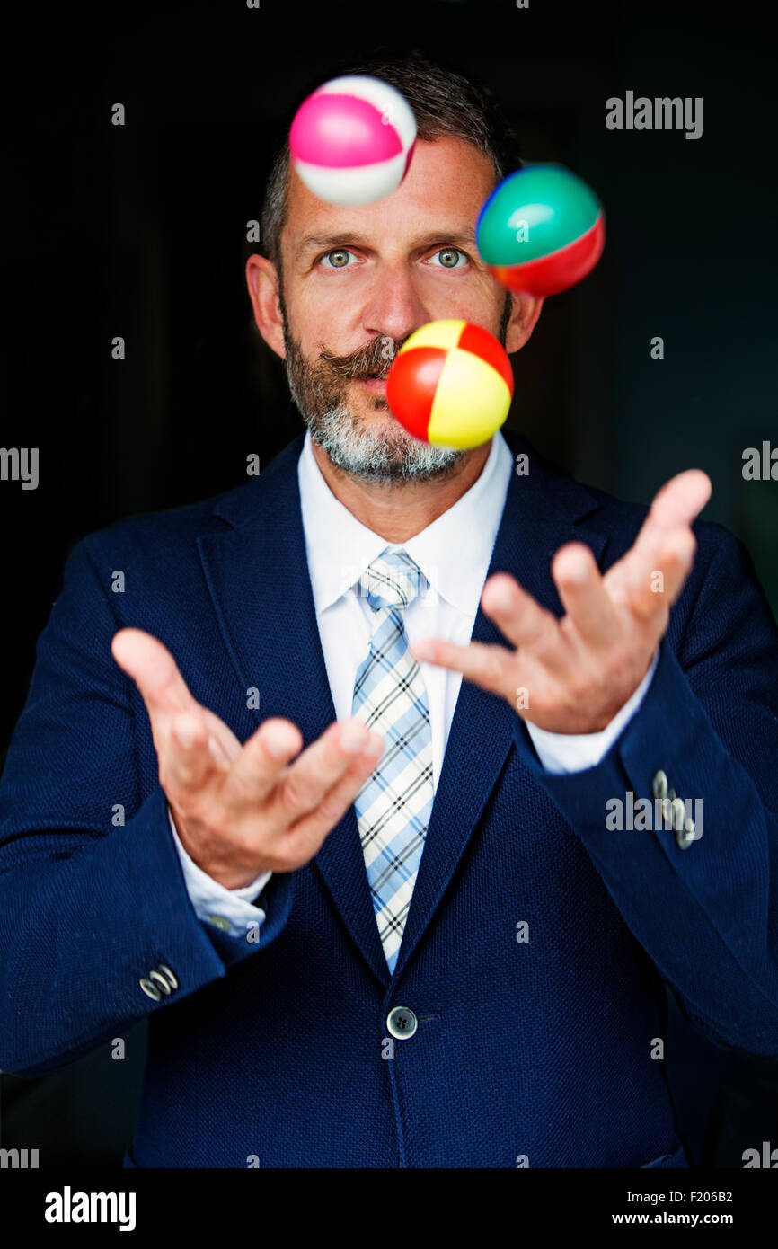 handsome businessman juggles three balls Stock Photo - Alamy