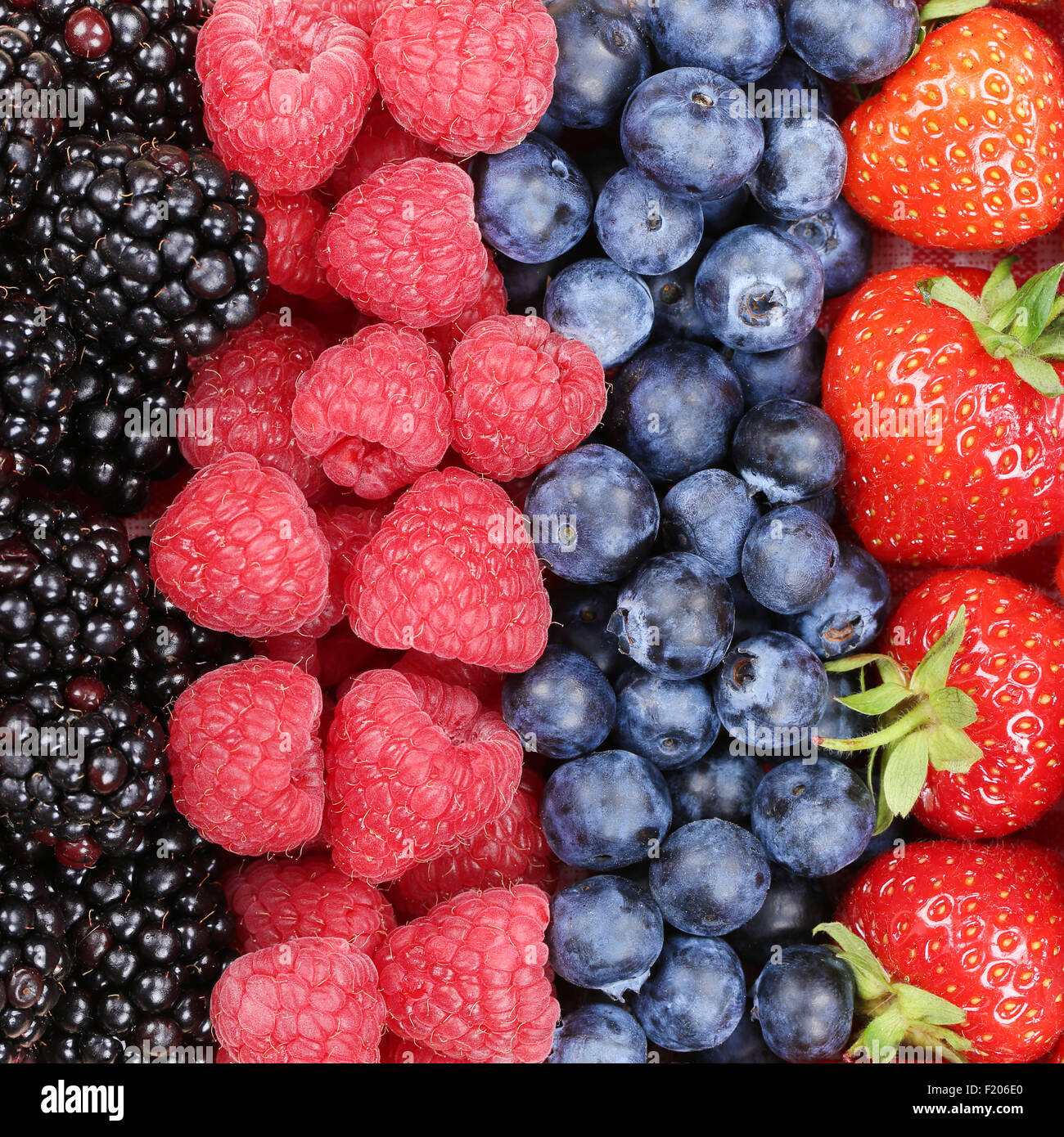 Berry fruits background in a row with strawberries, blueberries ...