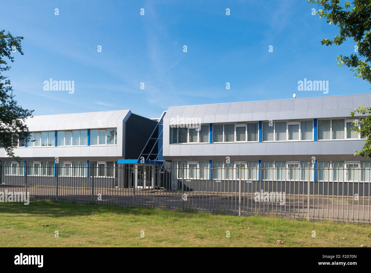 exterior of a modern office building behind a gate Stock Photo - Alamy