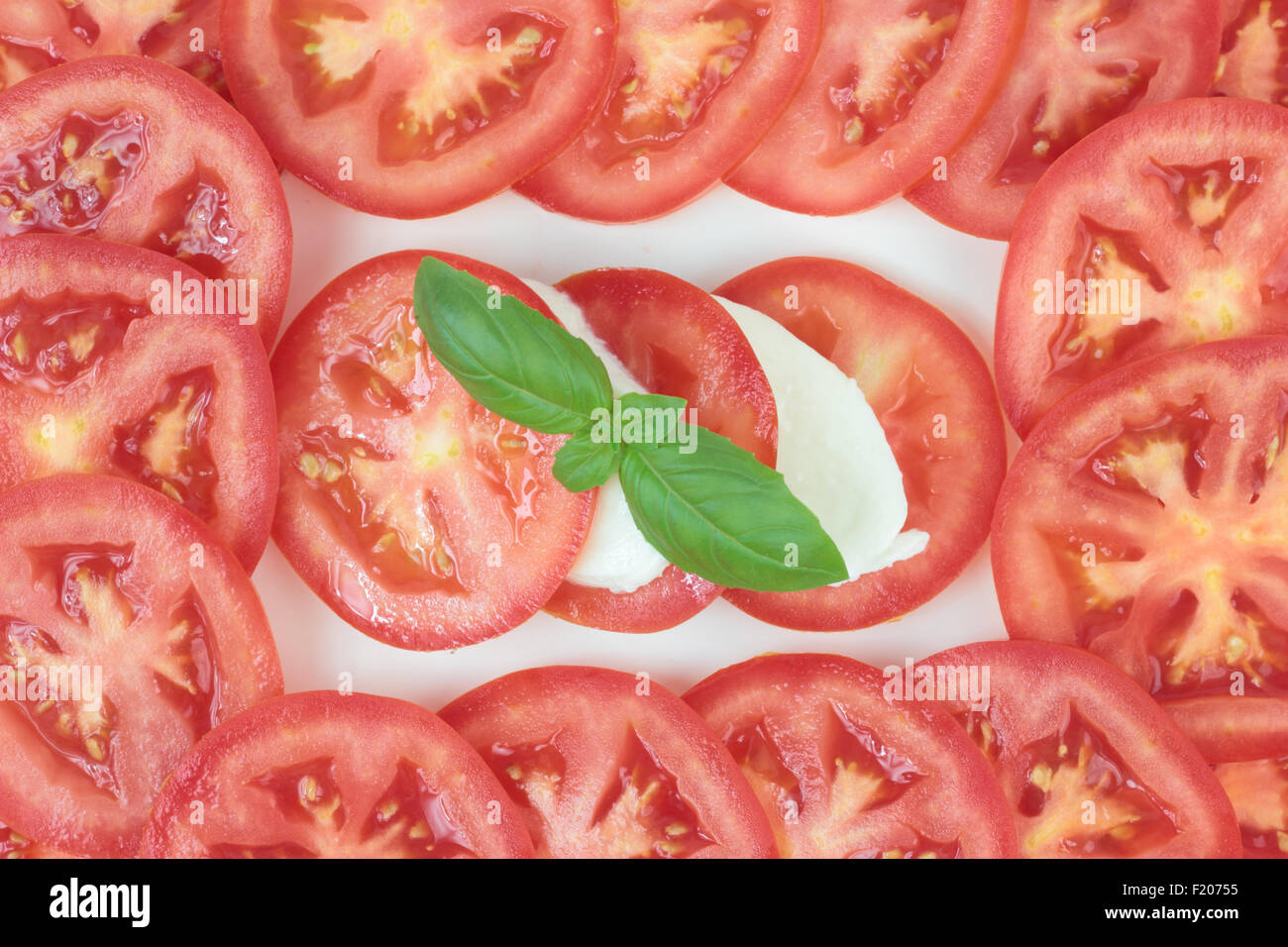 Tomato, mozzarella and basil leaves - food frame Stock Photo - Alamy