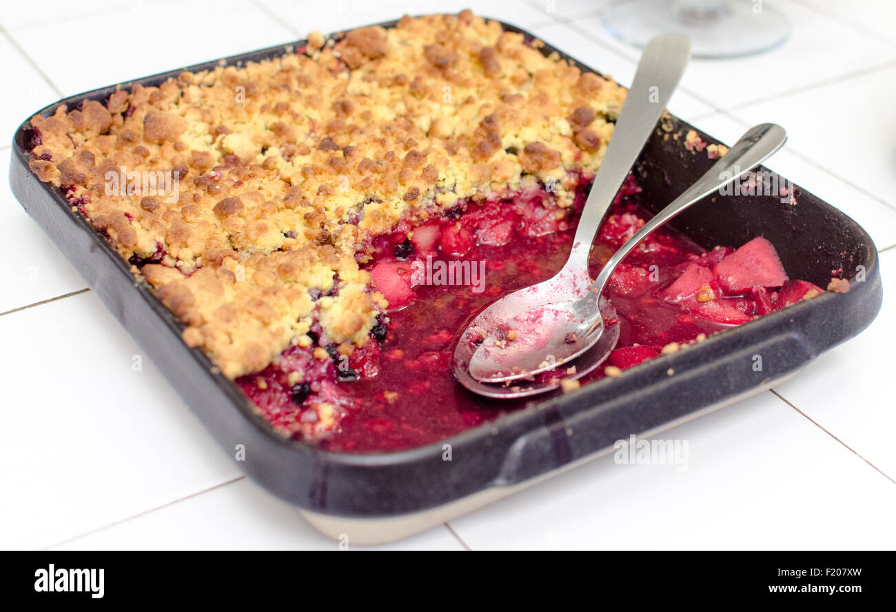 A red cranberry crumble with two spoons Stock Photo - Alamy