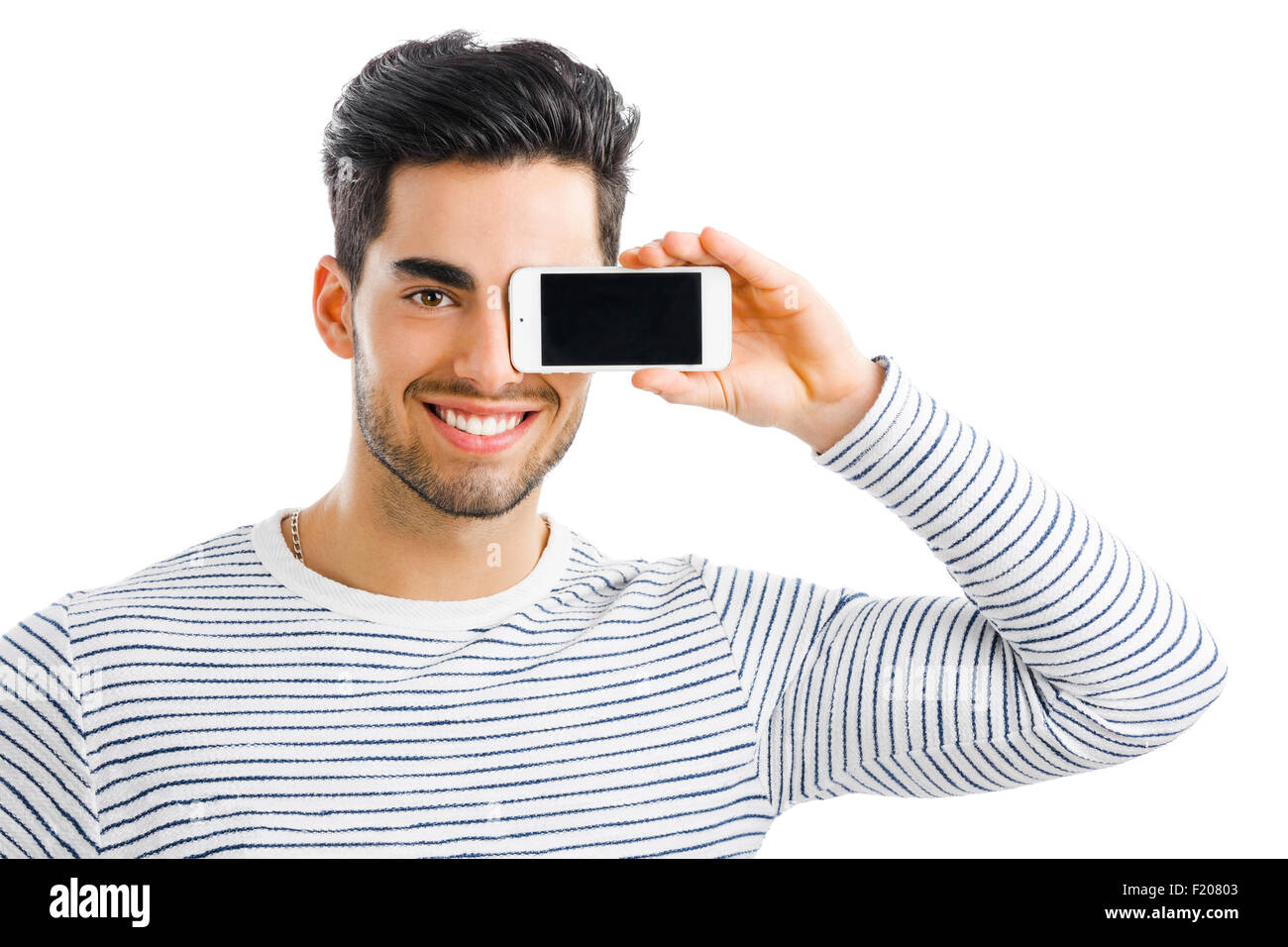 Handsome young man looking and showing something on his phone, isolated ...