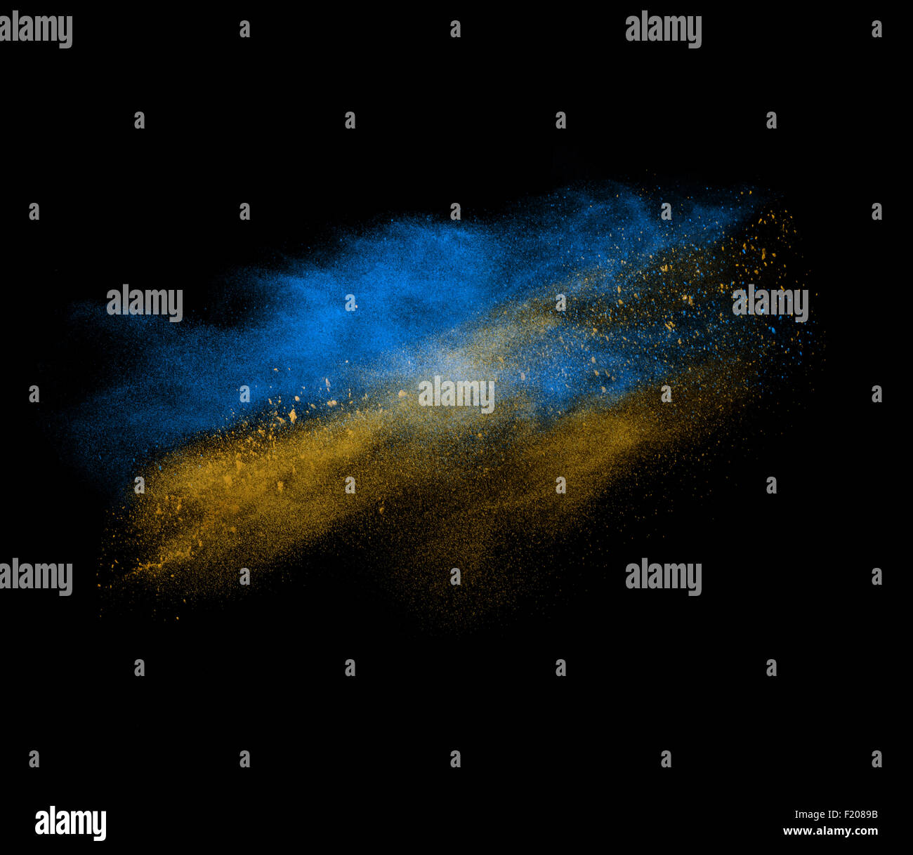 Blue and yellow powder explosion isolated on black Stock Photo - Alamy