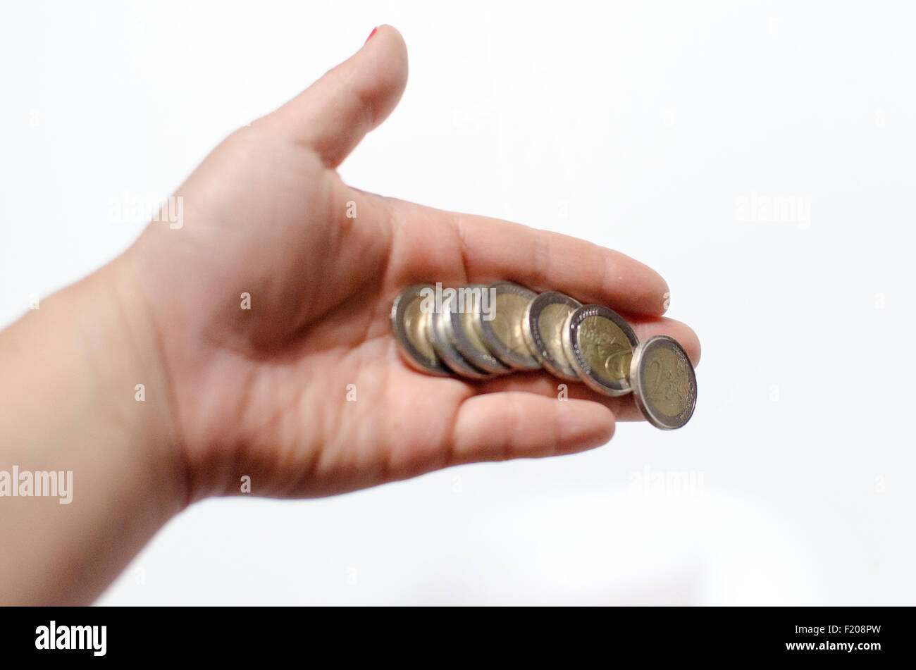 Coins falling down from a hand Stock Photo - Alamy