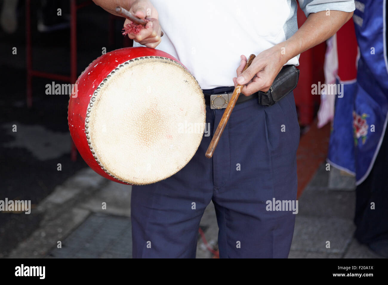 a mans hand beating a drum at a ceremony Stock Photo - Alamy
