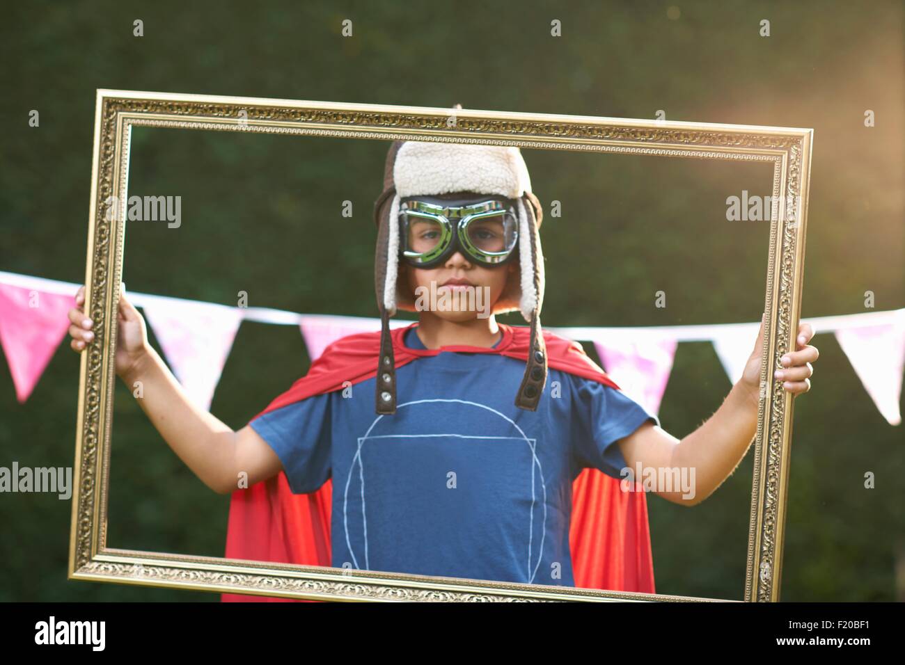 Pretending child wearing cape hi-res stock photography and images - Alamy
