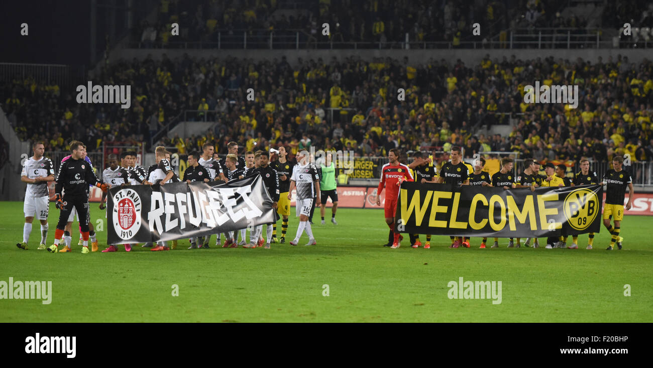 Hamburg's (L) and Dortmund's players hold banner in their hands which ...