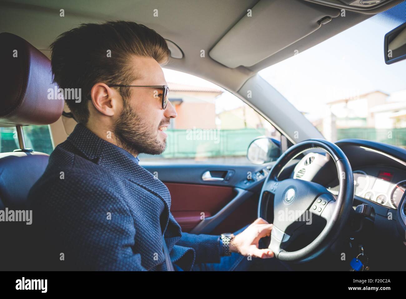 Stylish young man driving car Stock Photo - Alamy