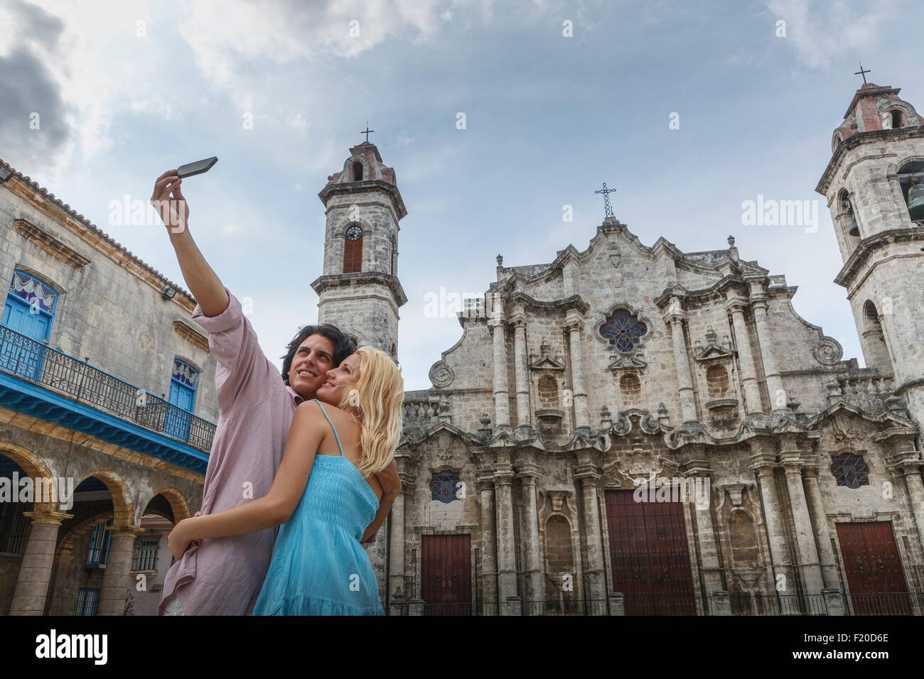 Young couple taking smartphone selfie in the Plaza de la Cathedral of ...