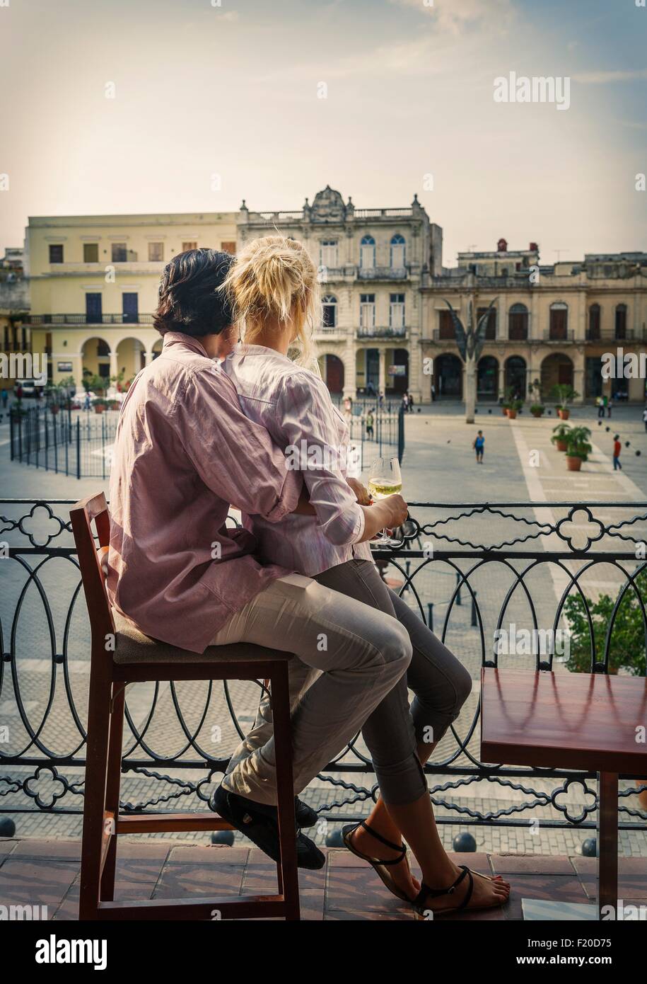 Romantic young couple looking out from restaurant balcony in Plaza ...