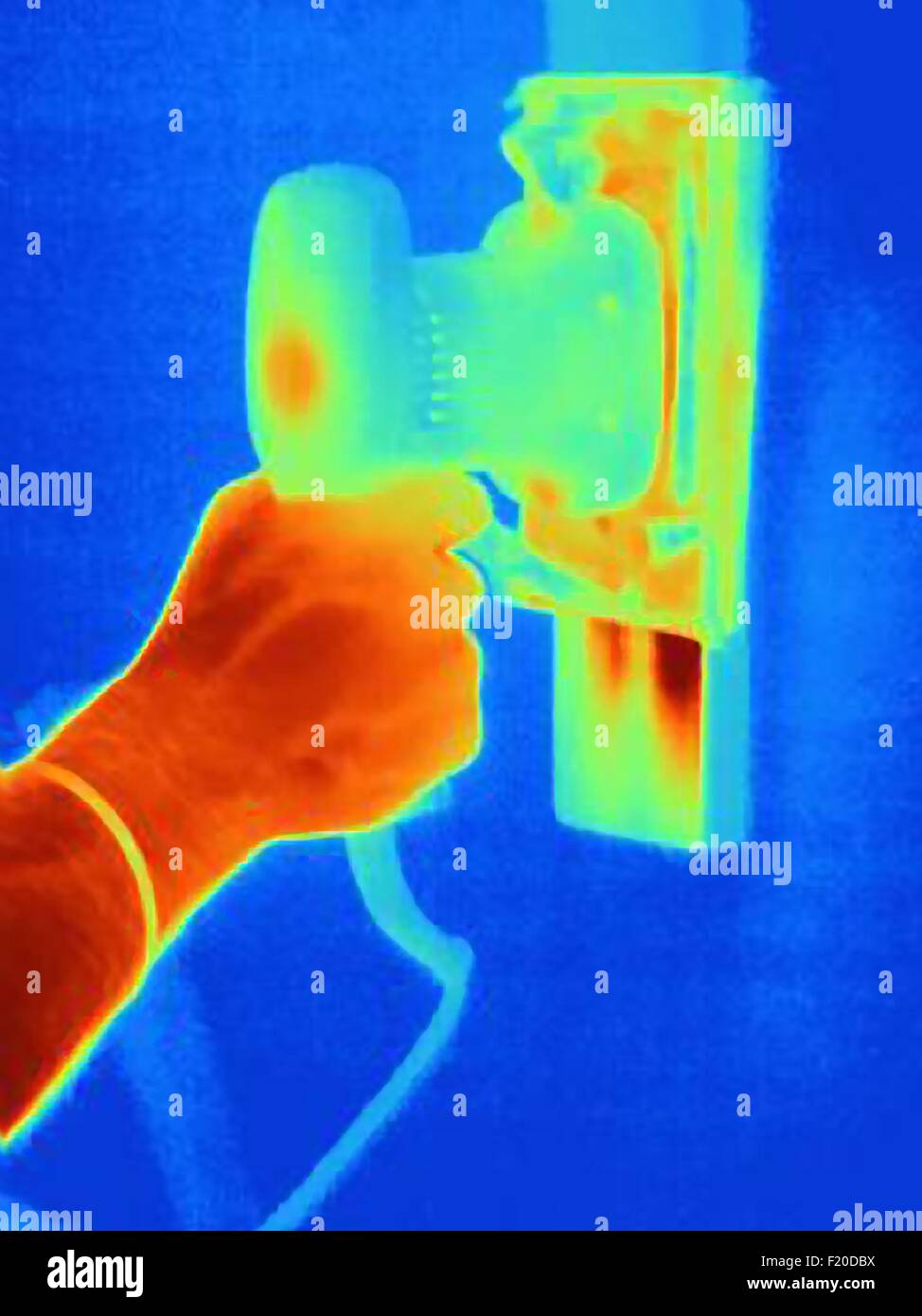 Thermal photograph of a mans hand using sander on wall Stock Photo - Alamy