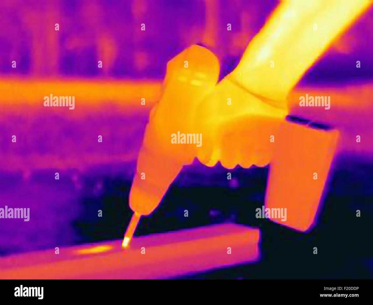 Thermal photograph of young mans hand using a hand drill Stock Photo ...