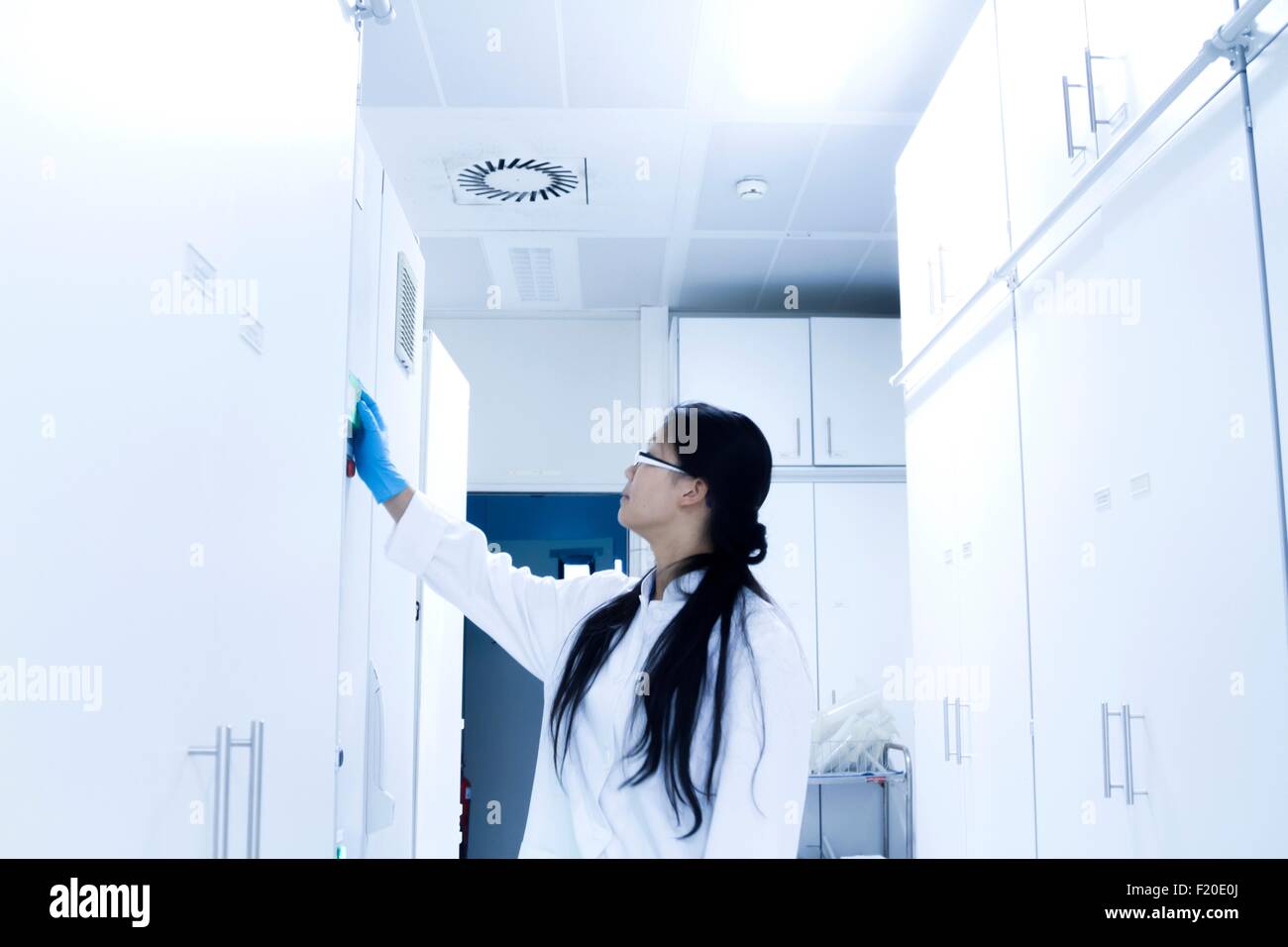 Female scientist opening sample cupboard in laboratory Stock Photo - Alamy
