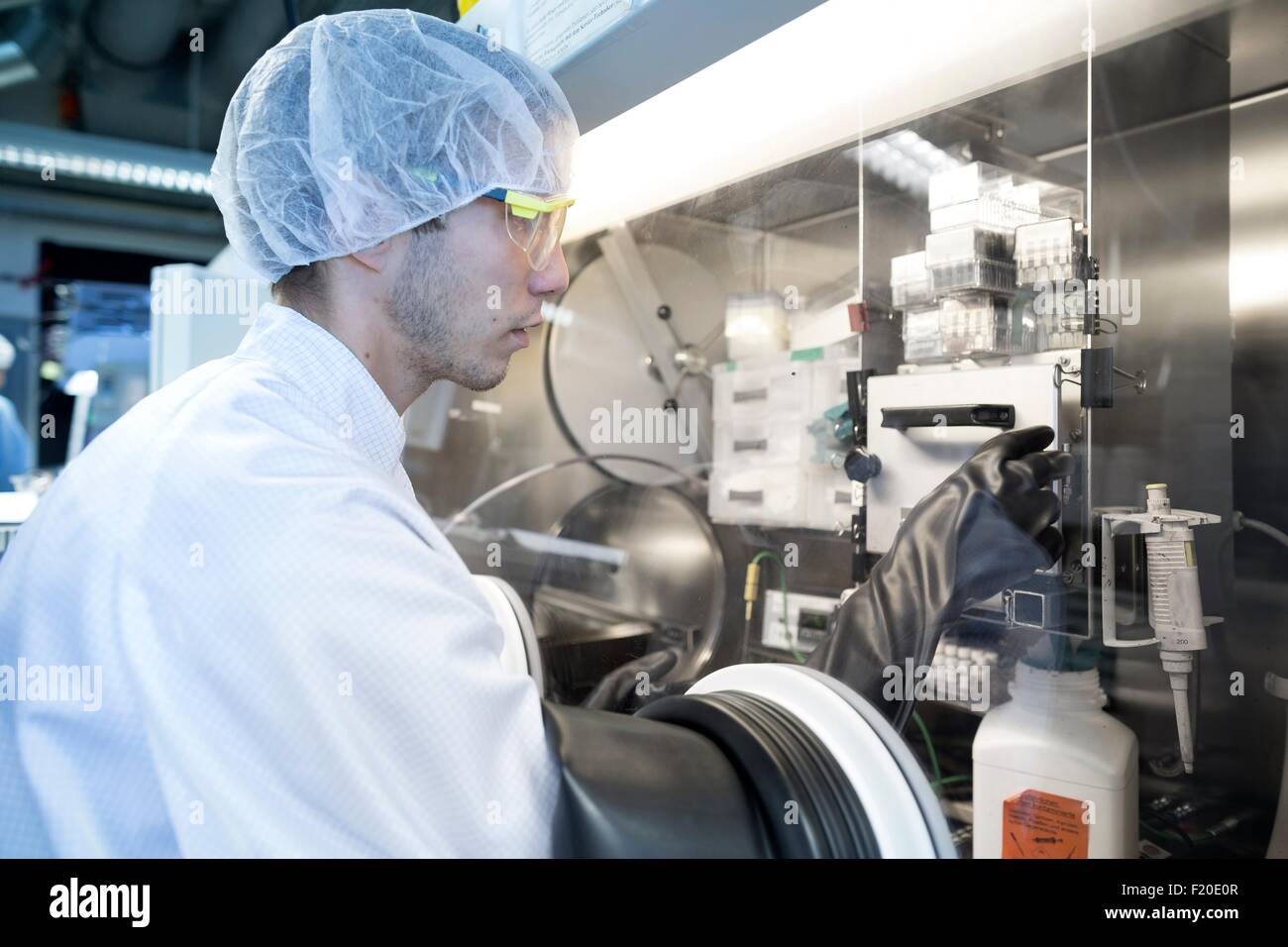 Male scientist adjusting switch in fume hood in lab cleanroom Stock ...