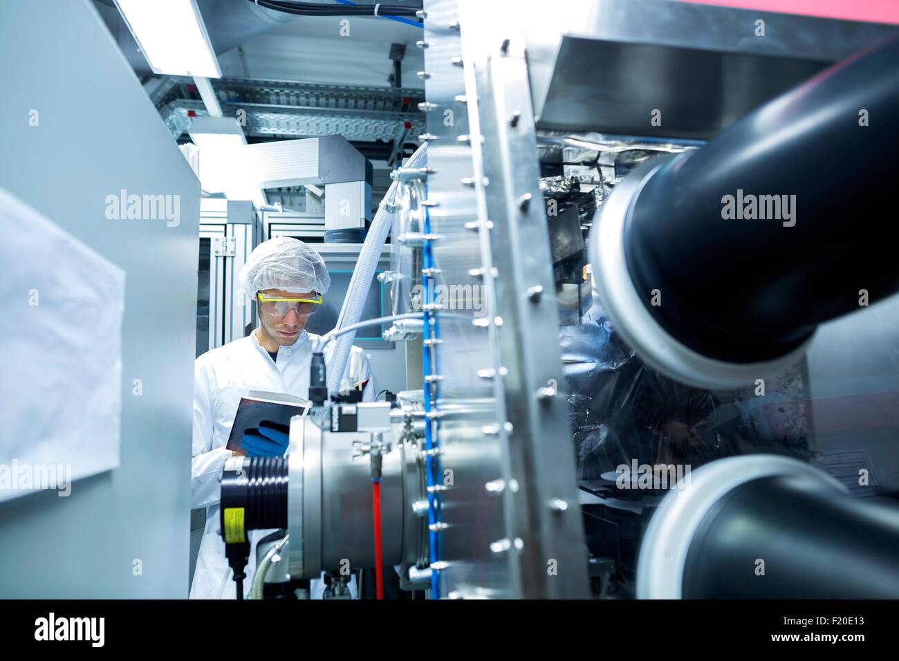 Male scientist writing notes in lab cleanroom Stock Photo - Alamy