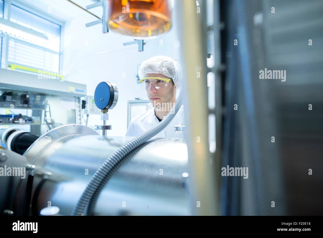 Male scientist reading equipment gauge in lab cleanroom Stock Photo - Alamy