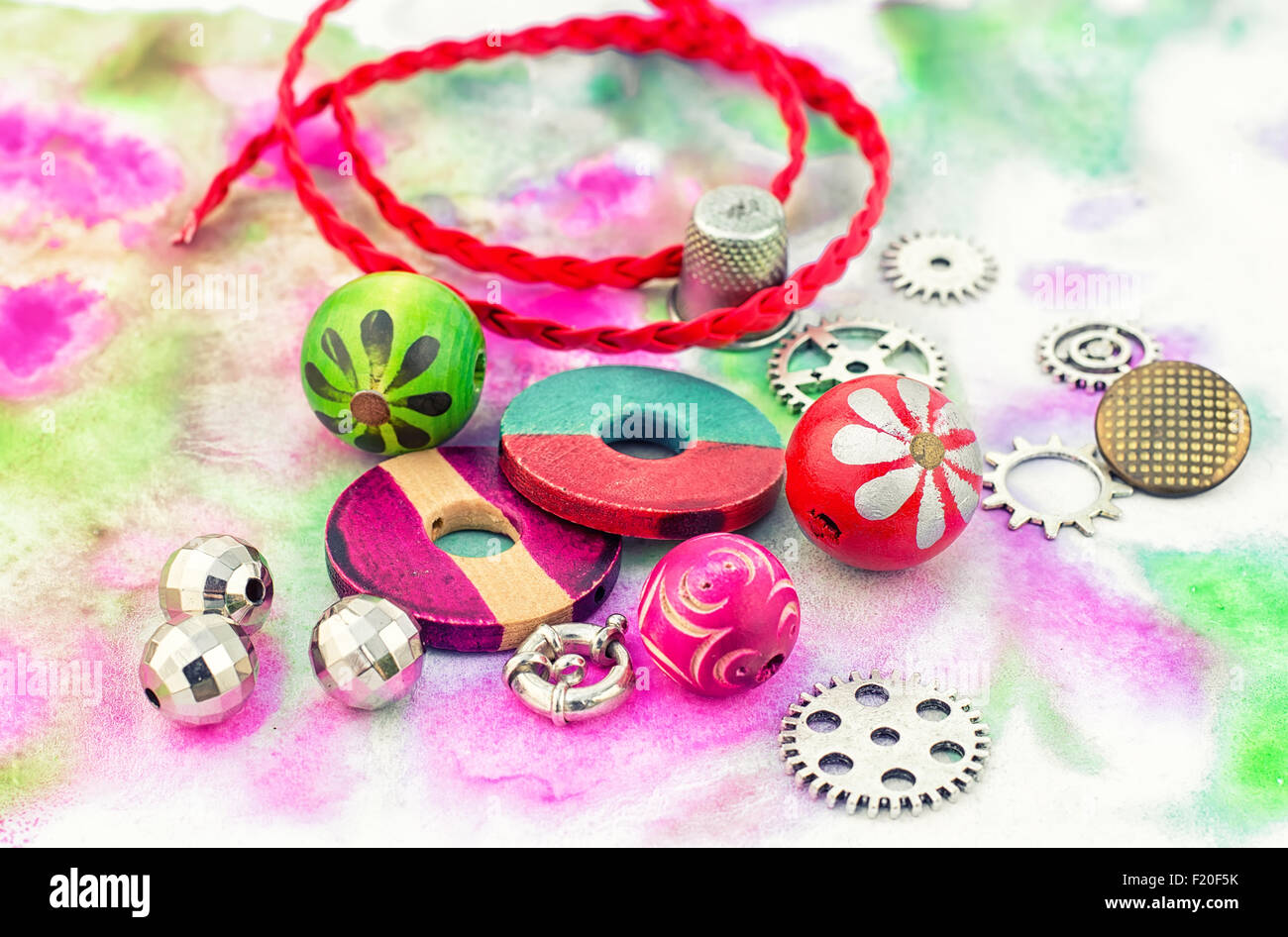 Set beads,threads and fittings on painted background Stock Photo - Alamy