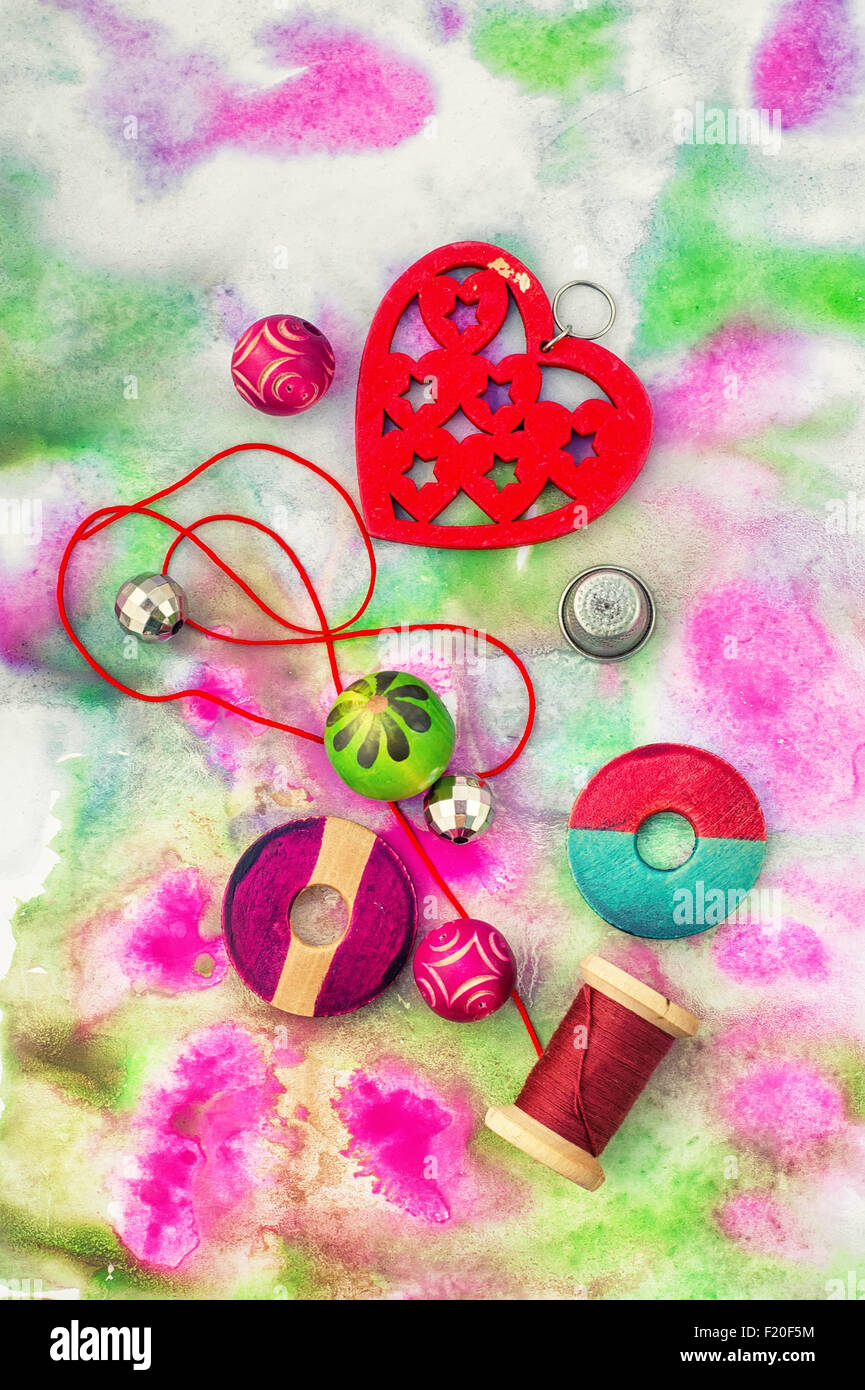 Set beads,threads and fittings on painted background Stock Photo - Alamy
