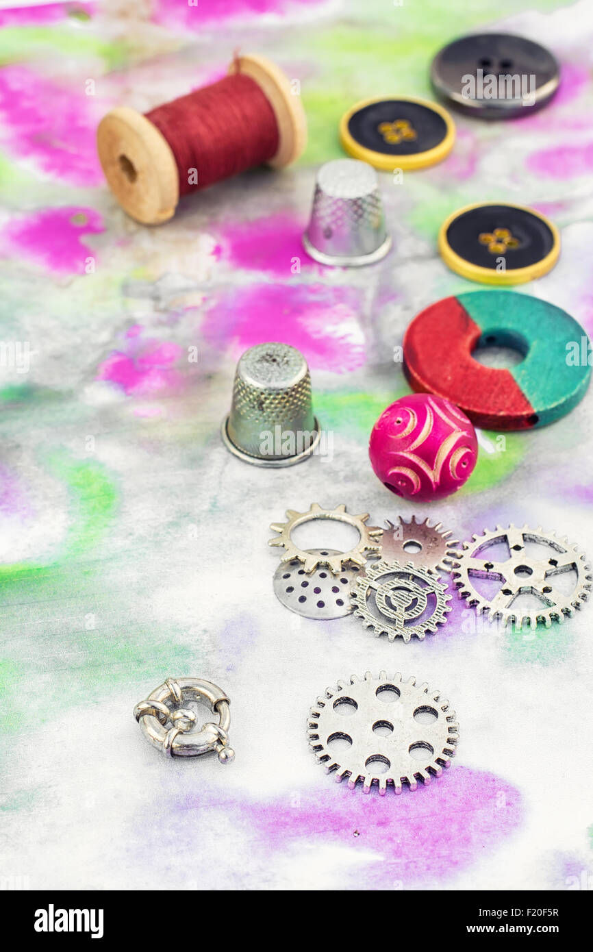 Set beads,threads and fittings on painted background Stock Photo - Alamy