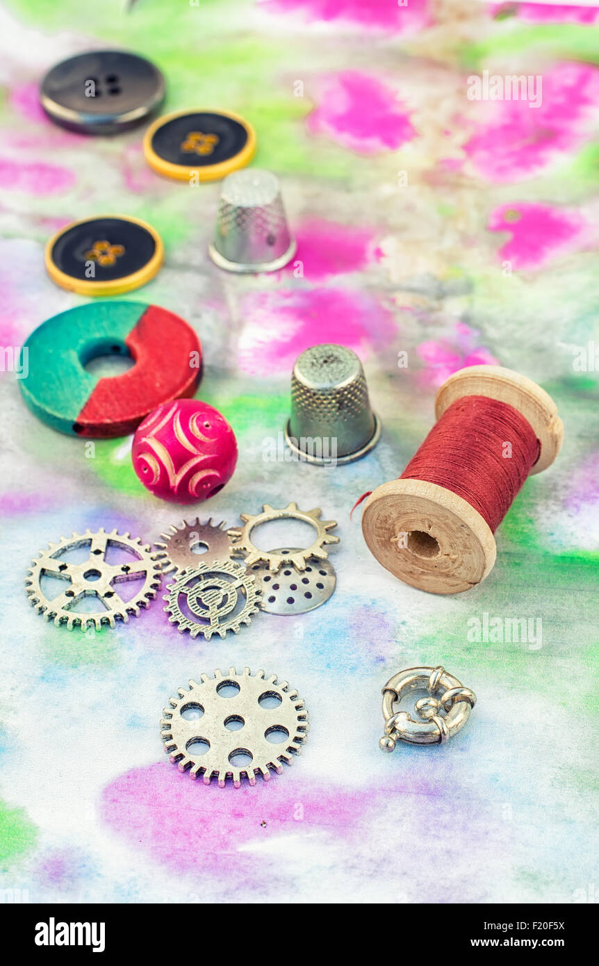 Set beads,threads and fittings on painted background Stock Photo - Alamy