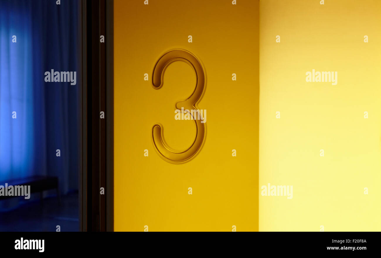 Room number 3 in hotel yellow door Stock Photo - Alamy