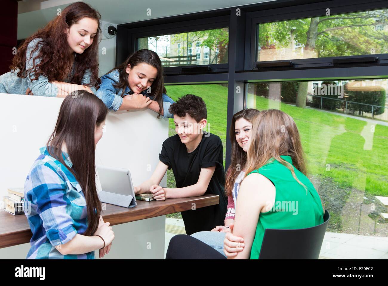 Group of students relaxing in library Stock Photo - Alamy