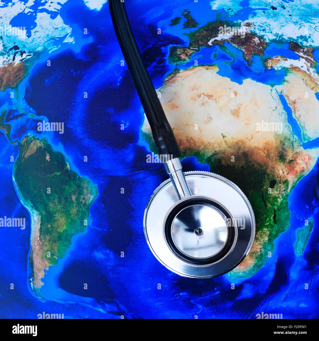 closeup of a stethoscope on a world map (furnished by NASA), as ...
