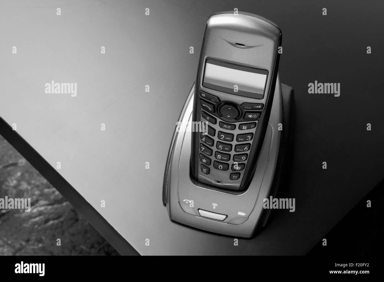 Cordless telephone on a grey table black & white Stock Photo - Alamy