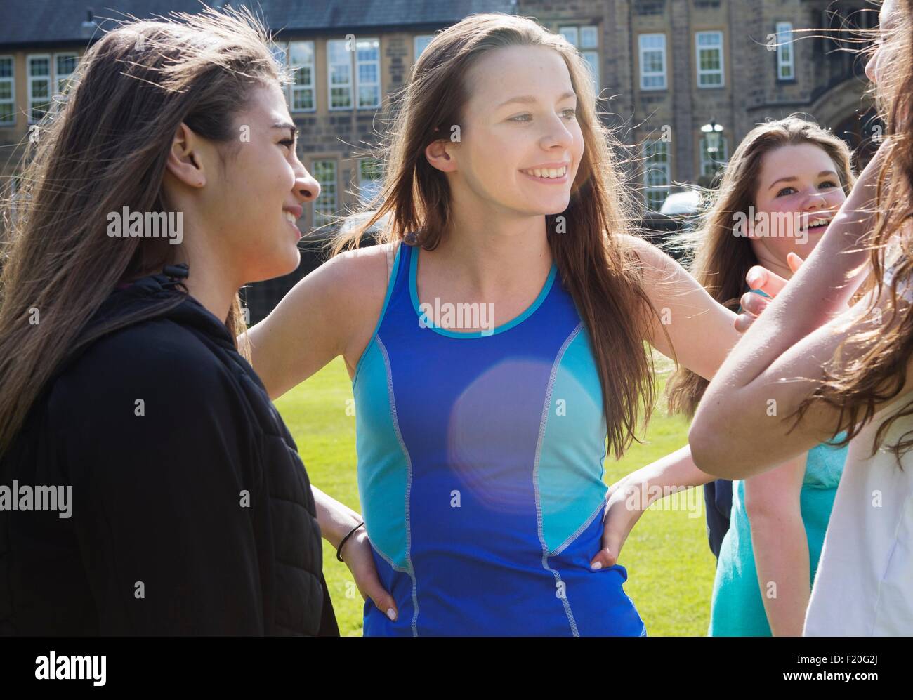 Group of students taking break in field Stock Photo - Alamy
