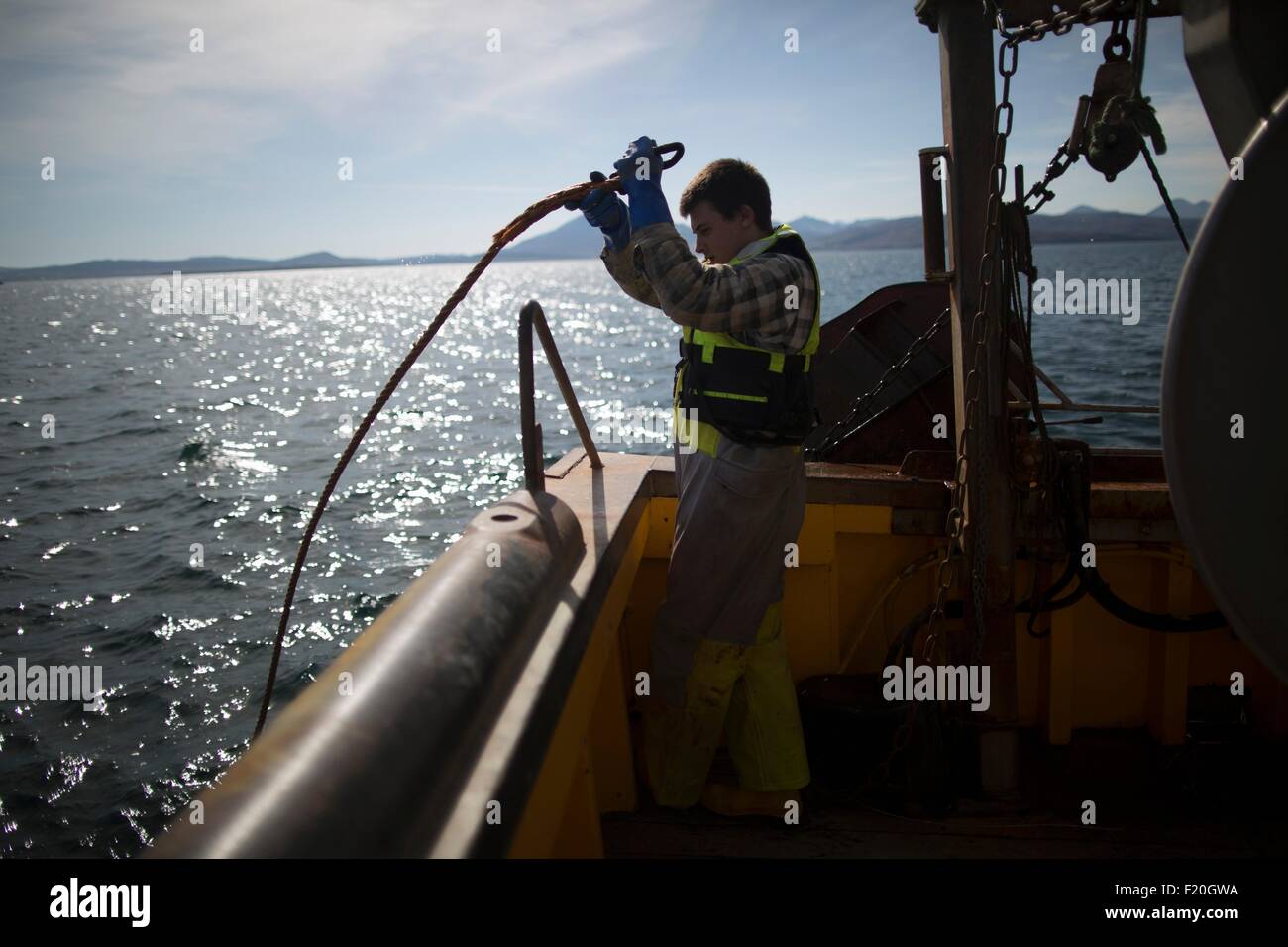 Fisherman reeling in net, Isle of Skye, Scotland Stock Photo - Alamy