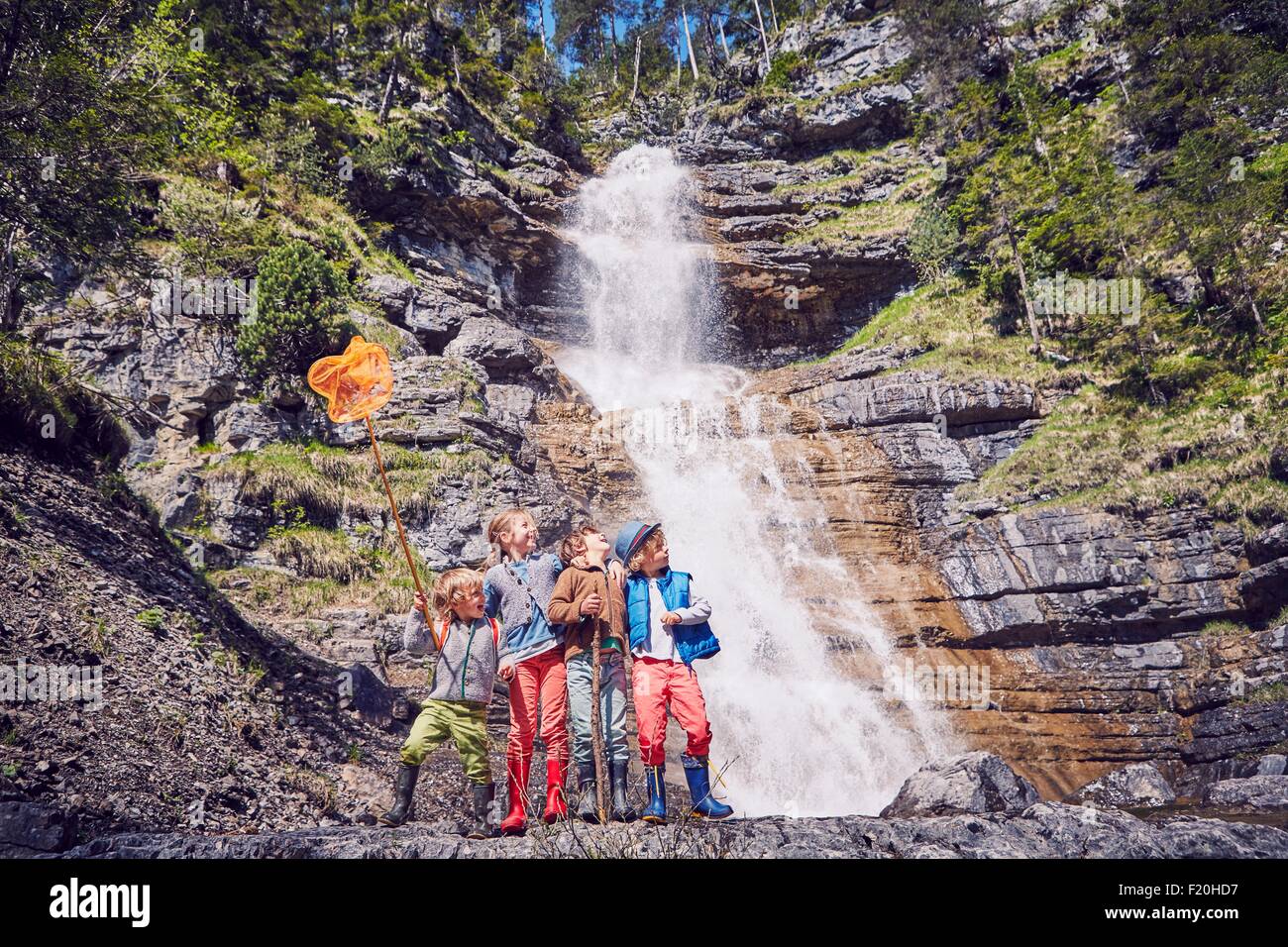 Group of children exploring by waterfall Stock Photo - Alamy
