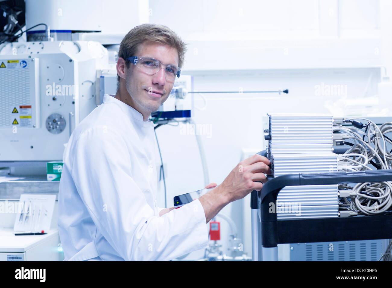 Portrait of male scientist adjusting control panel in laboratory Stock ...